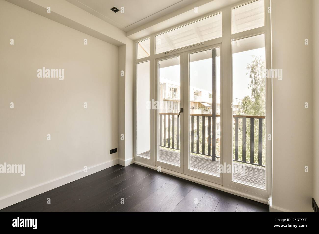 An airy and bright modern room featuring large floor-to-ceiling windows ...