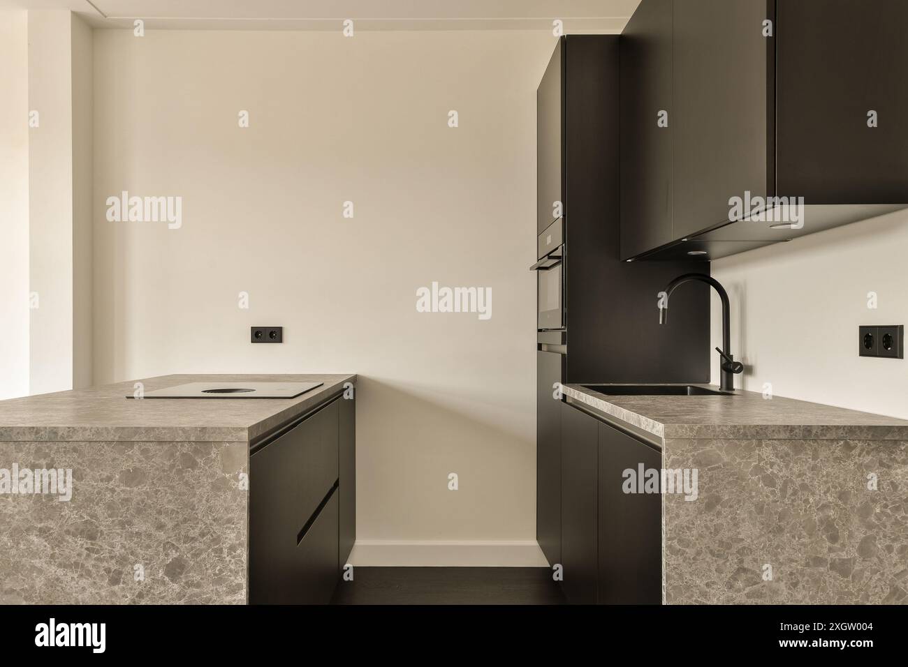A contemporary kitchen showcases minimalist style with dark cabinetry ...
