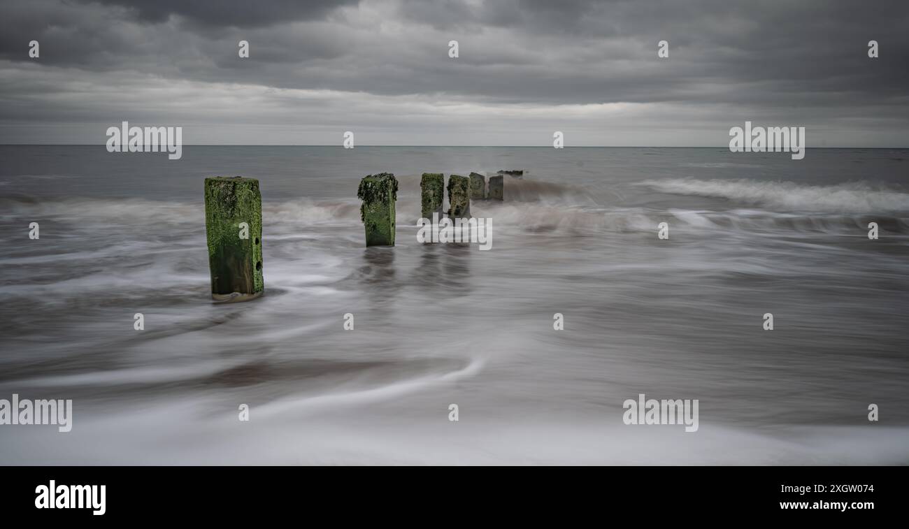 Youghal strand Groynes, on a cold spring evening Stock Photo - Alamy