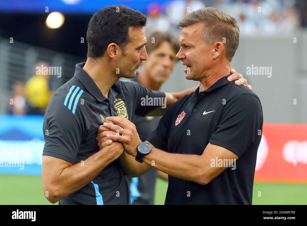 Argentina s head coach Lionel Scaloni L and his colleague Canada s ...