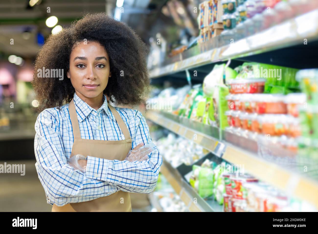Serious supermarket manager arms crossed hi-res stock photography and ...