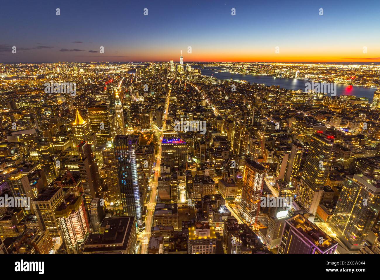 Illuminated Skyline of Manhattan, New York in the evening twilight ...