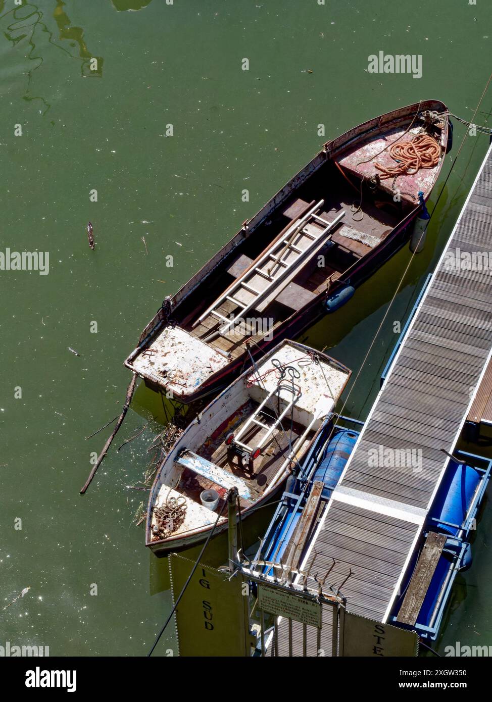 Two somewhat run-down boats at a jetty, on a branch of the Rhine Stock ...