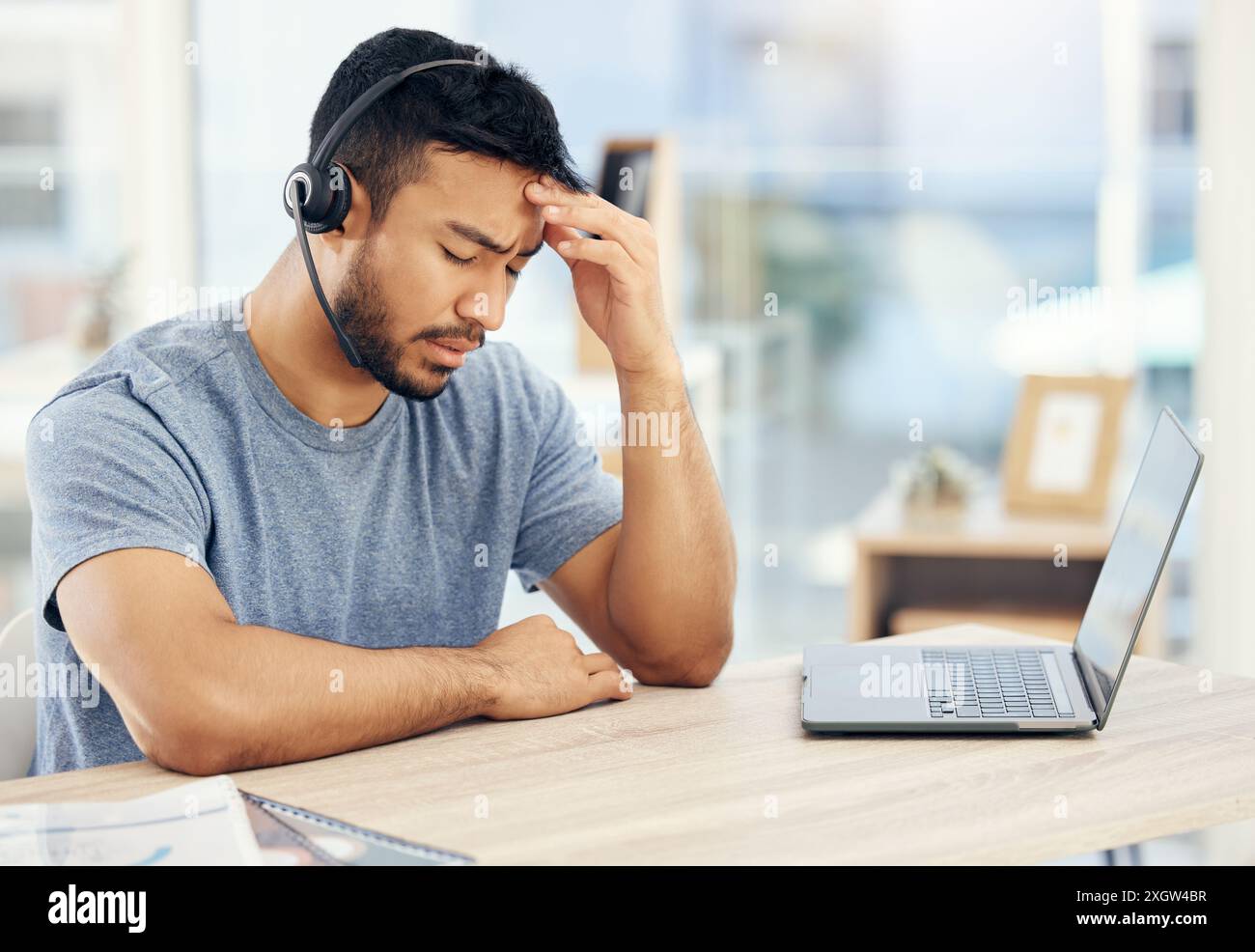 Customer service, call center and man on laptop with headache, stress ...