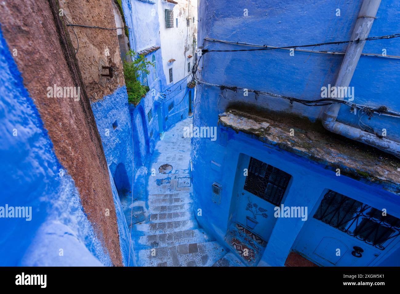 Under clear skies, the Chefchaouen alleys are a labyrinth of walls and ...