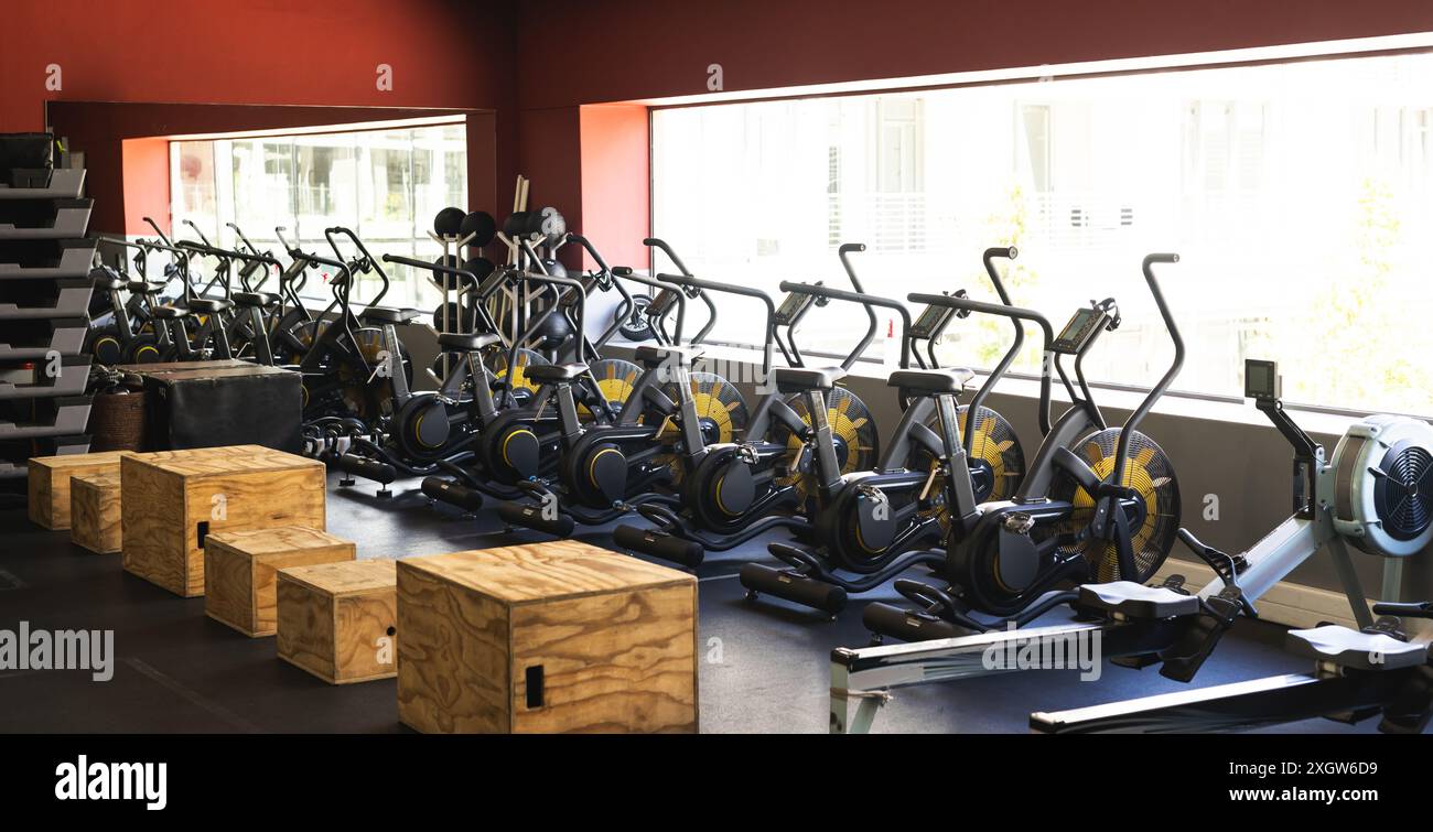 A gym with stationary bikes and workout equipment, with copy space ...