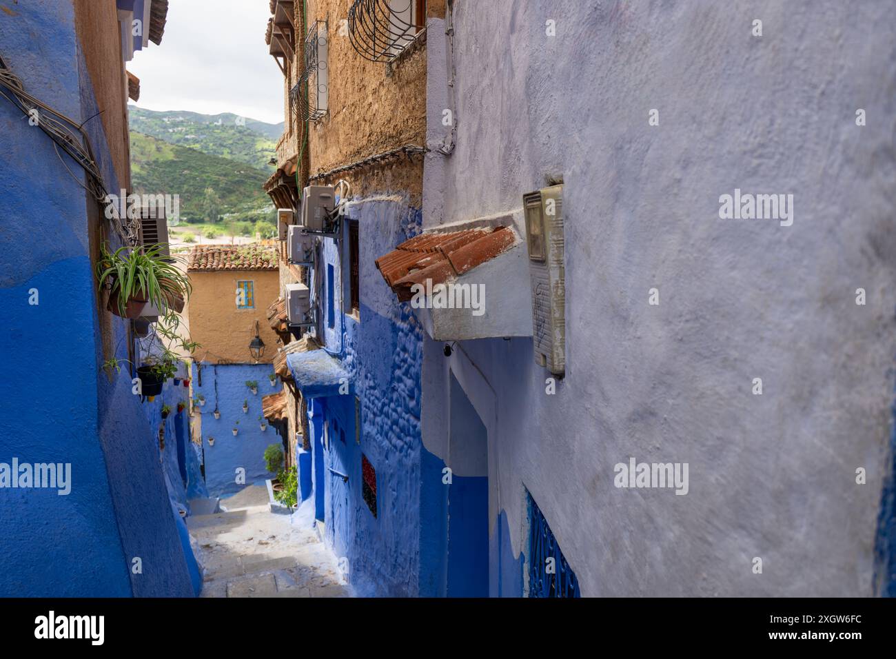 Under clear skies, the Chefchaouen alleys are a labyrinth of walls and ...