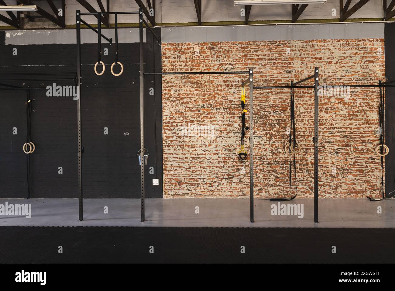 A well-equipped gym space features strength training equipment. The ...