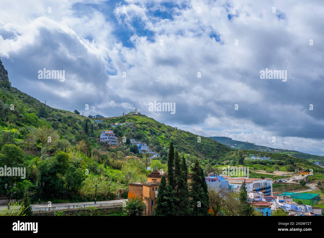 Panoramic view of country house with green mountains as background ...