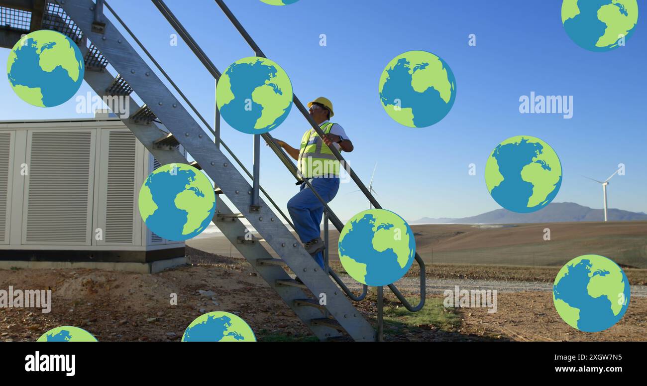 Image of globes over biracial male engineer and wind turbine. Green ...