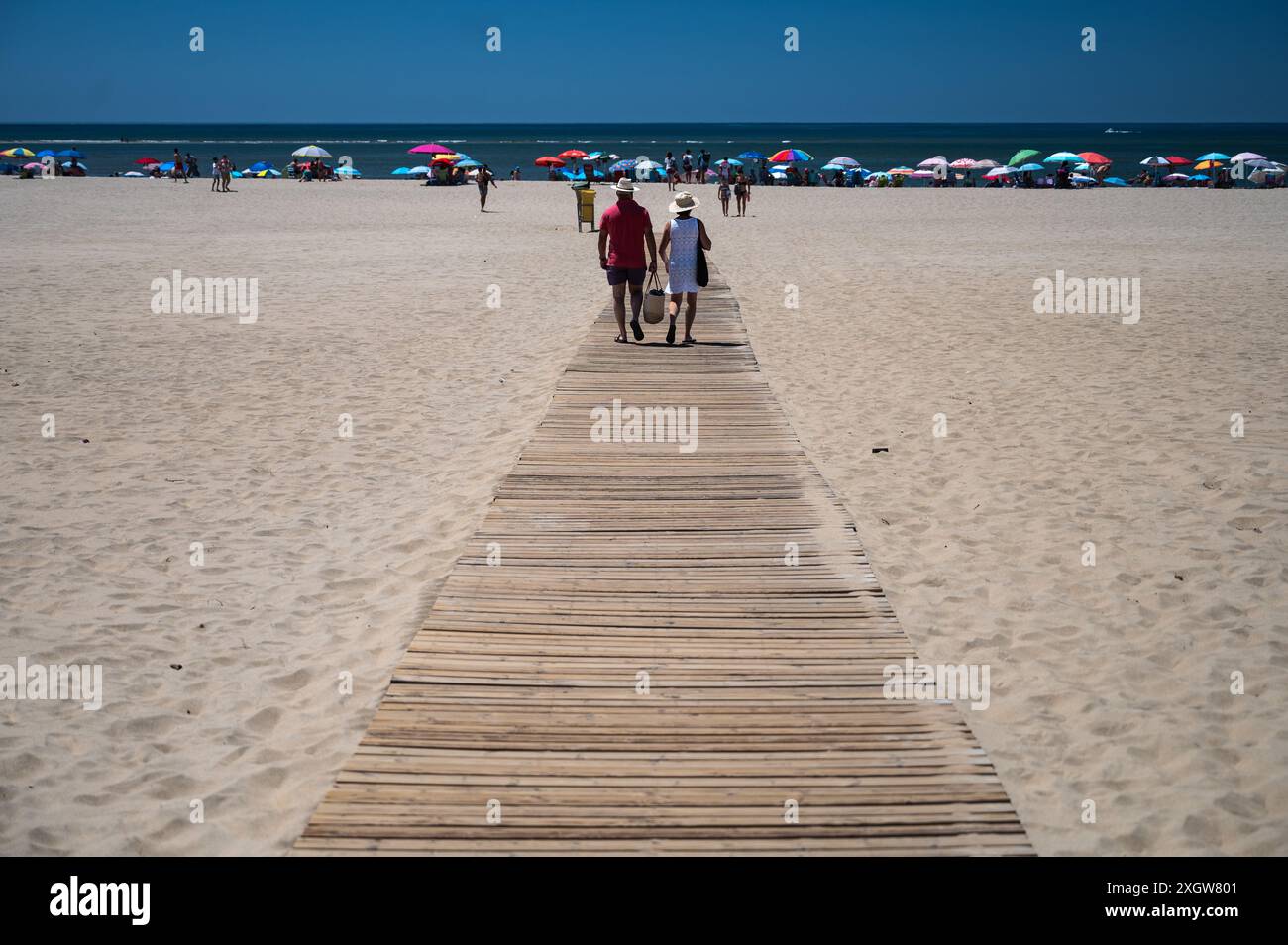 Tourists heading to the beach at Isla Canela Beach. Isla Canela is a ...