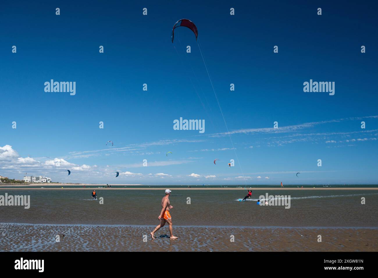 Kitesurfers during a summer day at Isla Canela Beach. Isla Canela is a ...