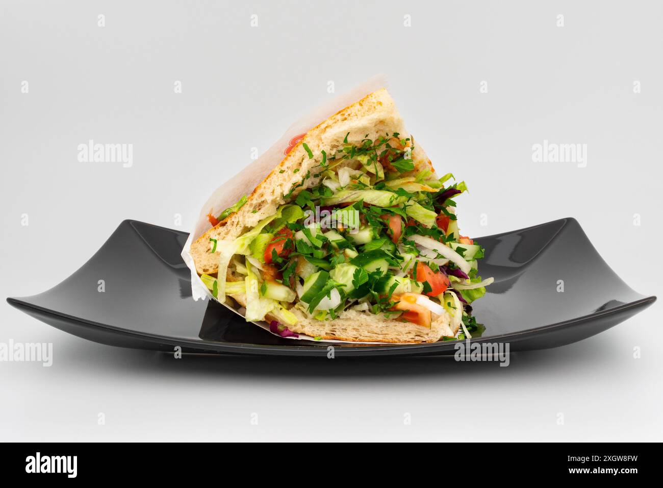 Veggie döner kebab with vegetables on a plate. The doner sandwich is ...