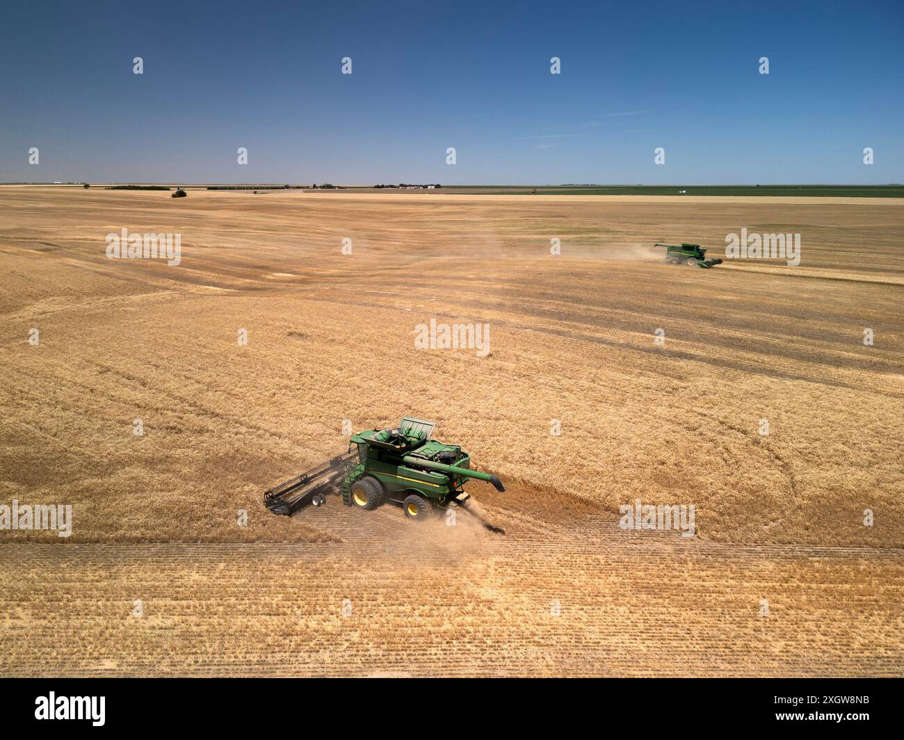View of harvester working a wheat field in western Kansas Stock Photo ...