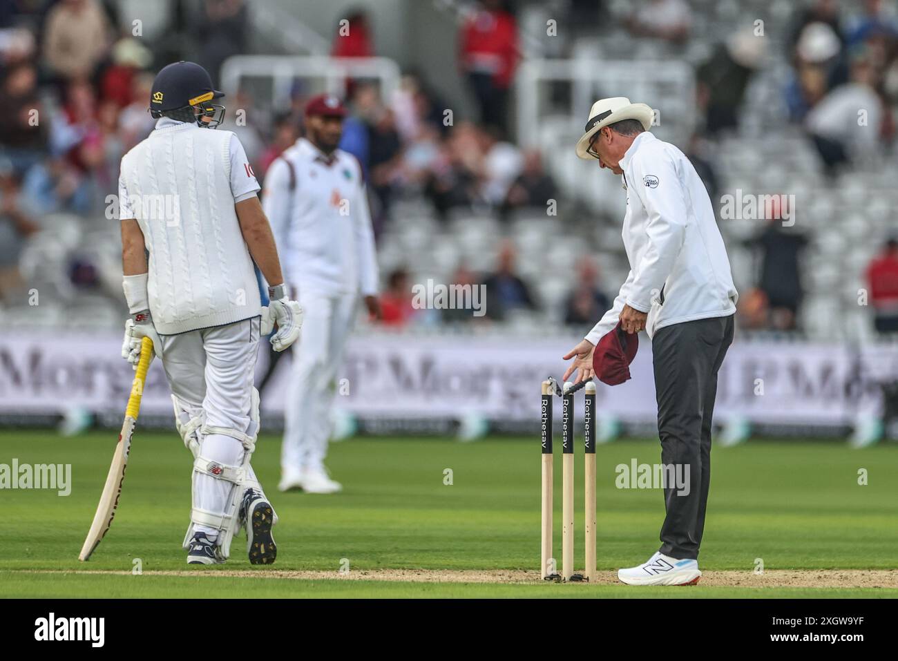 on-field umpire Rod Tucker knocks the stumps off for the end of play on ...