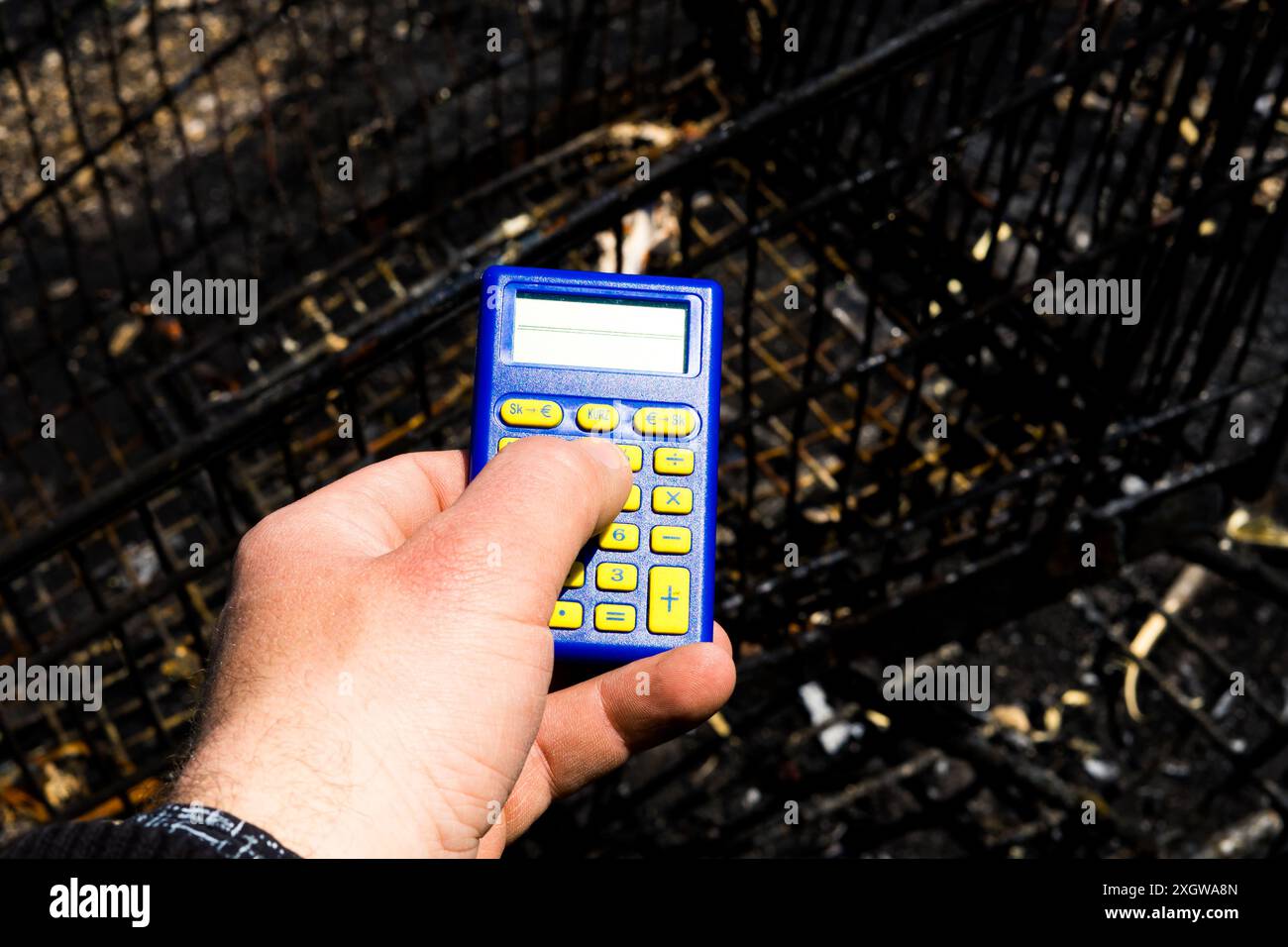 Blue calculator in dark soil, burnt ground after the fire Stock Photo ...