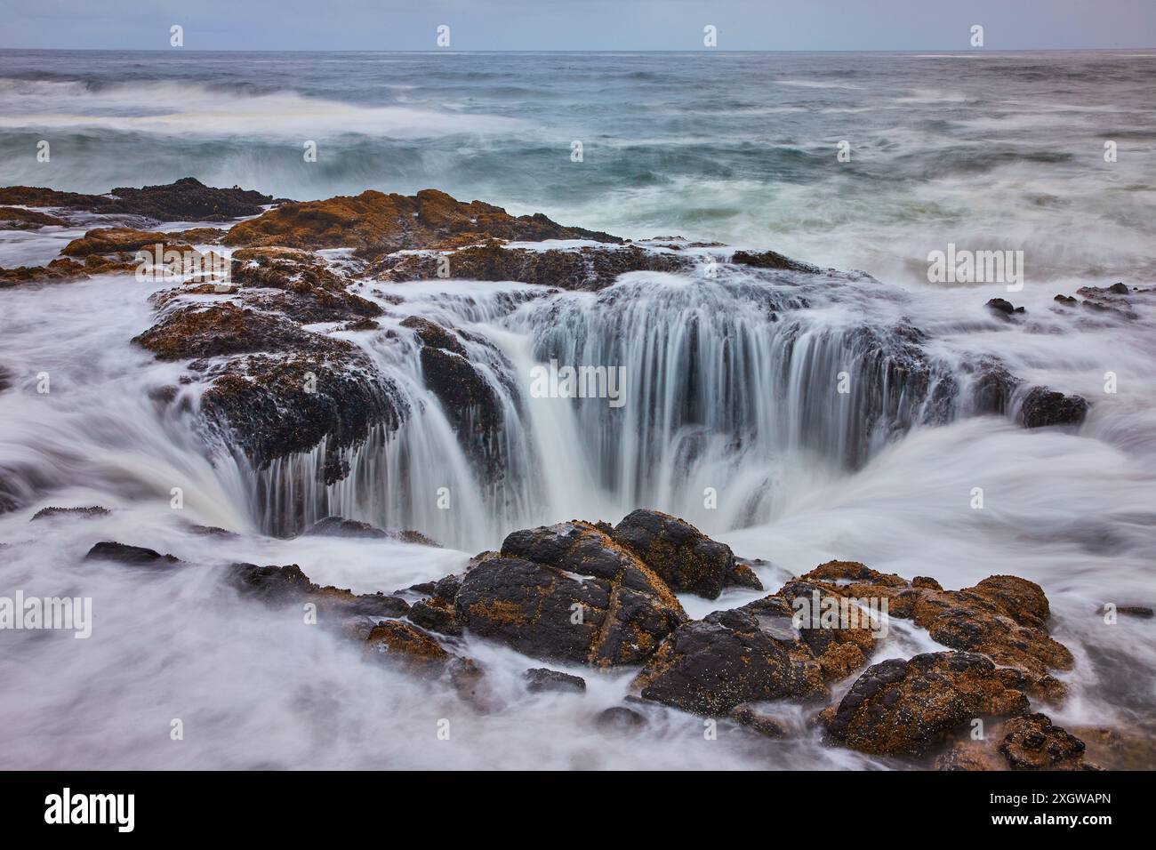 Ocean Sinkhole Cascade over Rocky Ledge Aerial View Stock Photo - Alamy
