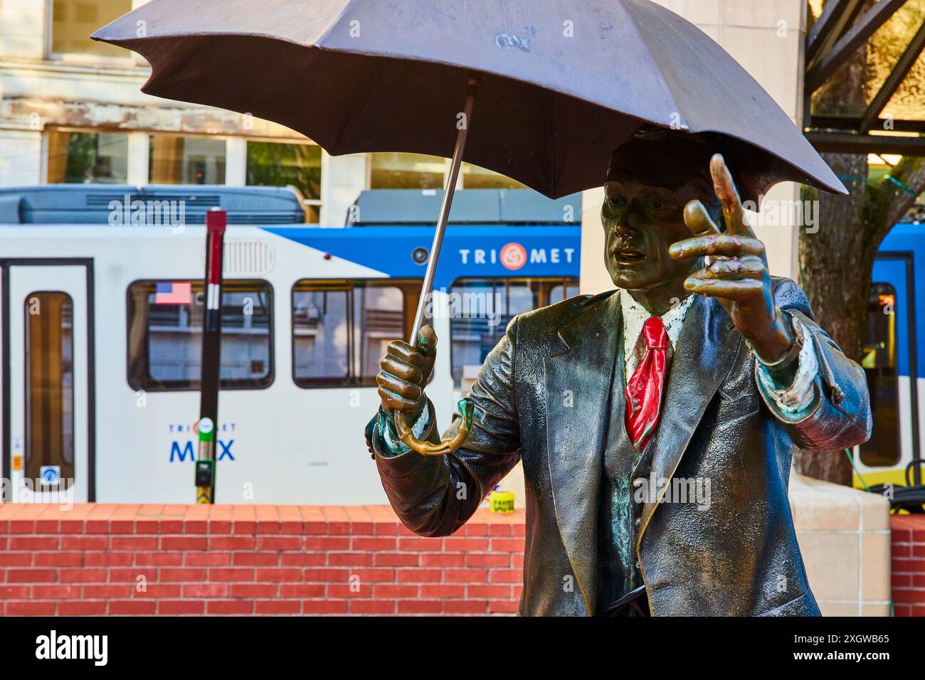 Bronze Statue with Red Tie and Tram in Motion Urban Scene Stock Photo ...