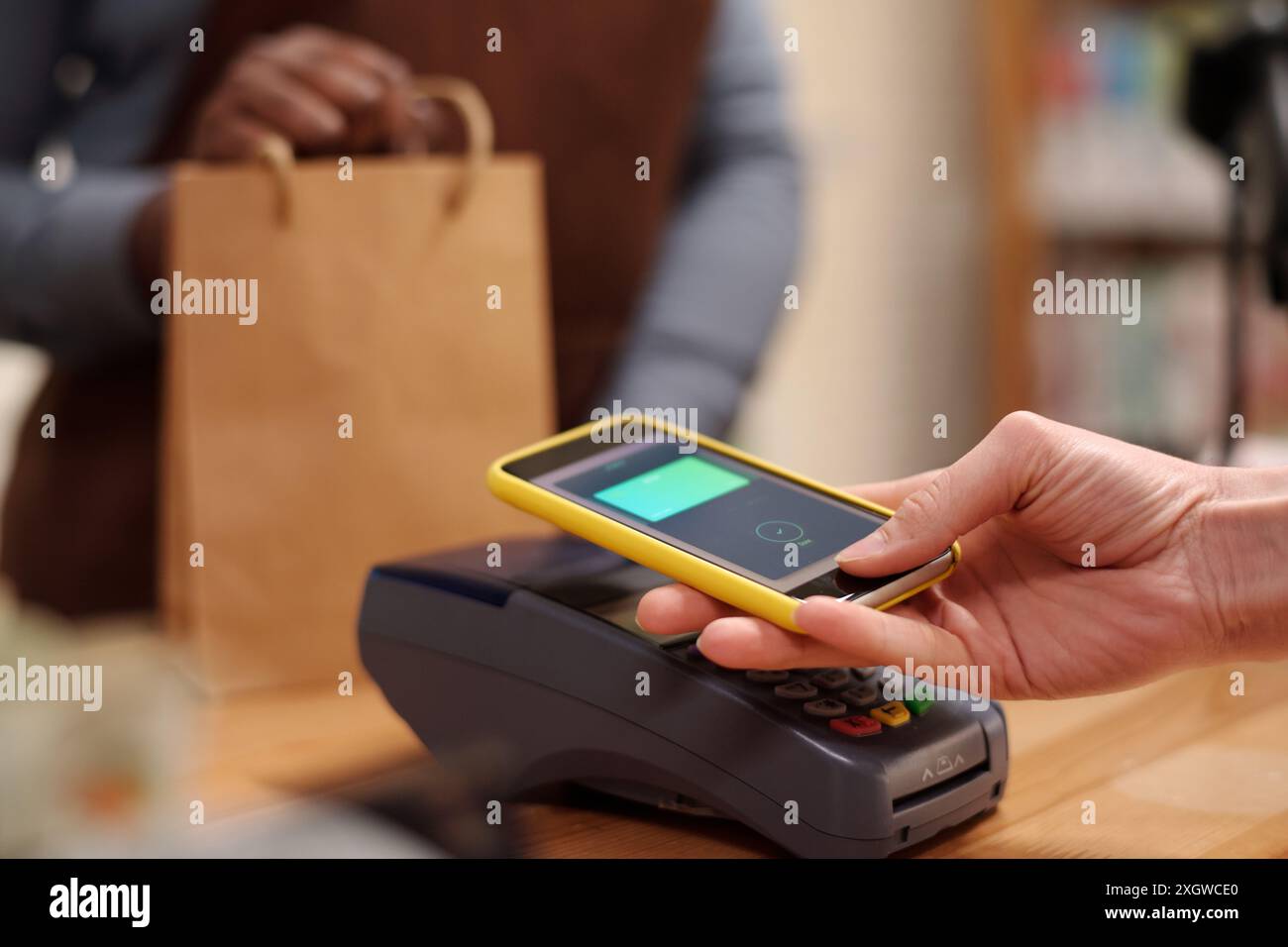 Hand of young female shopper with smartphone making contactless ...