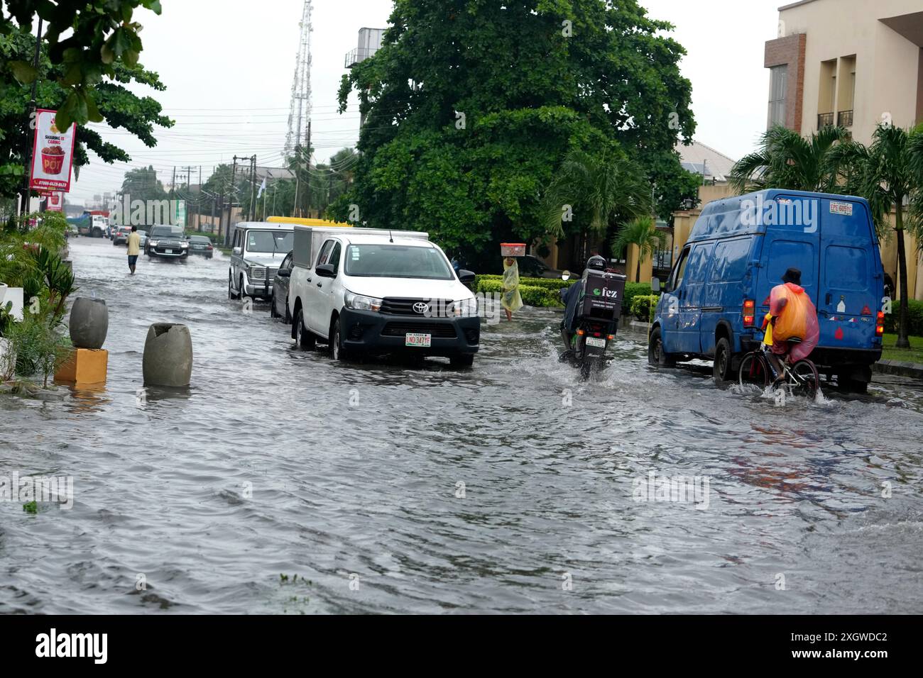 Cars drive on a flooded streets after a heavy downpour in Lagos ...