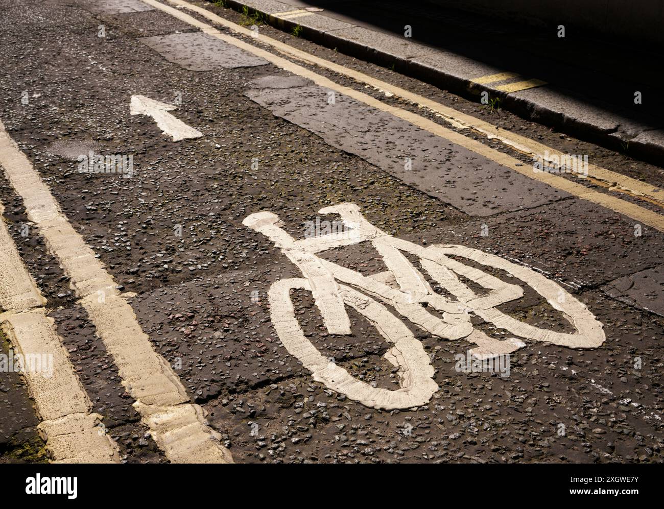 Bicycle lane marked by the symbol of a bicycle painted on the road with ...