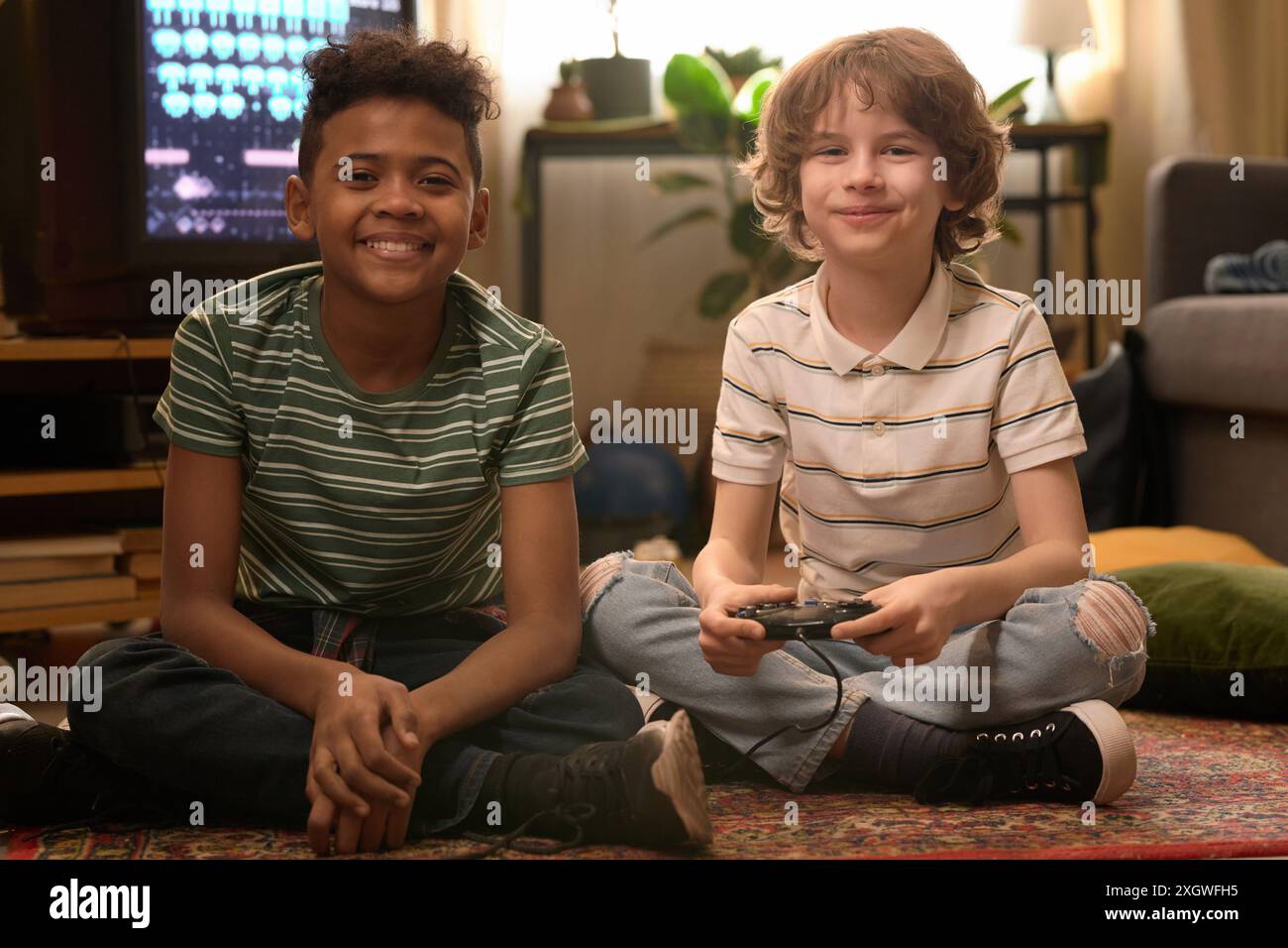 Two boys playing with game console hi-res stock photography and images ...