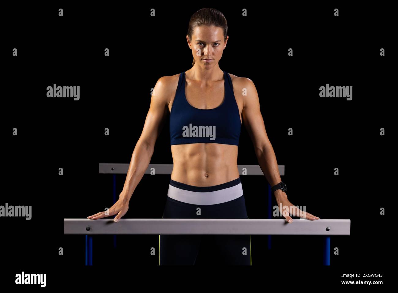 Fitness-focused young Caucasian female athlete demonstrates strength ...