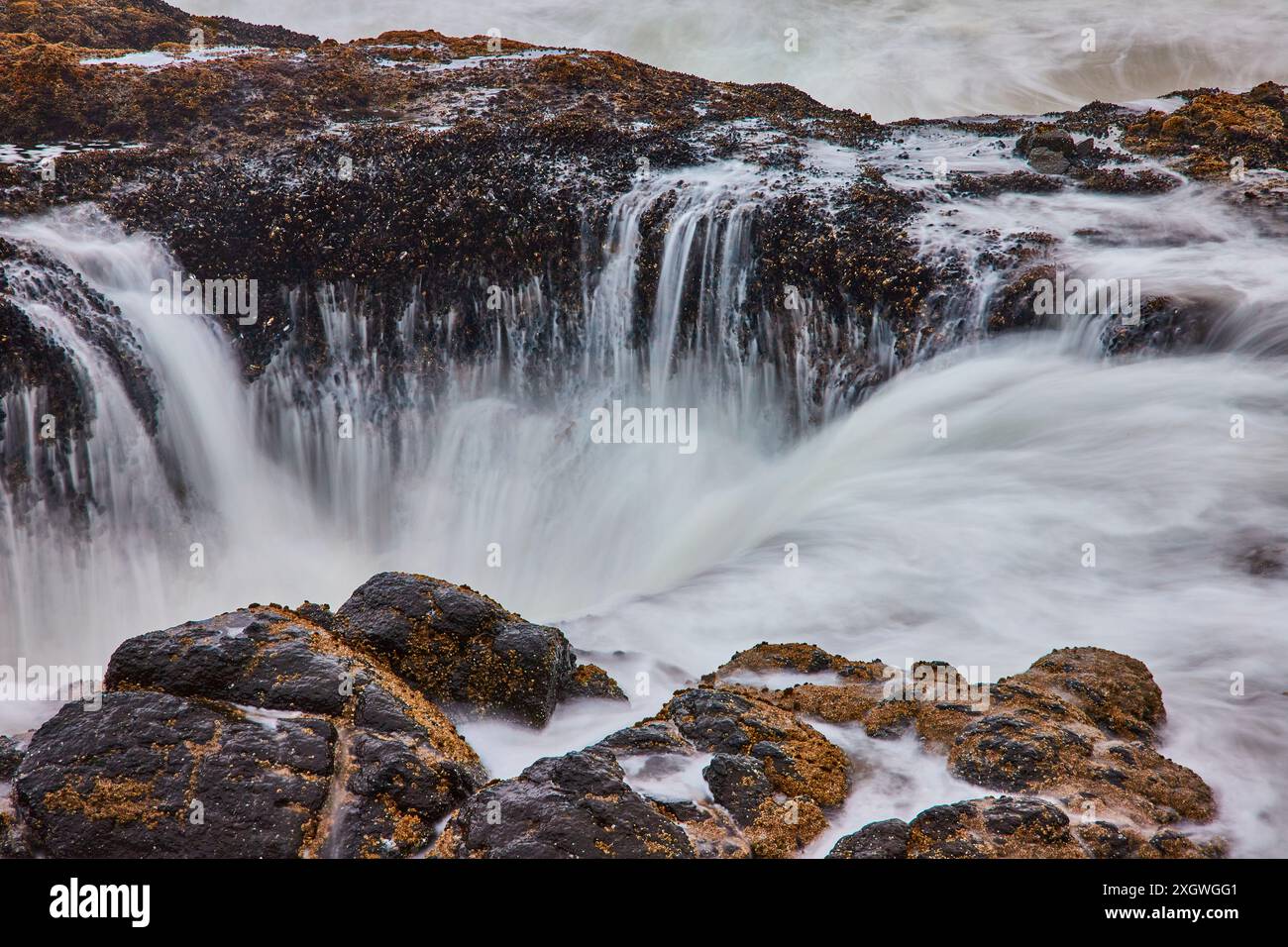 Thor's Well Waves Crashing on Volcanic Rocks at High Tide from Above ...