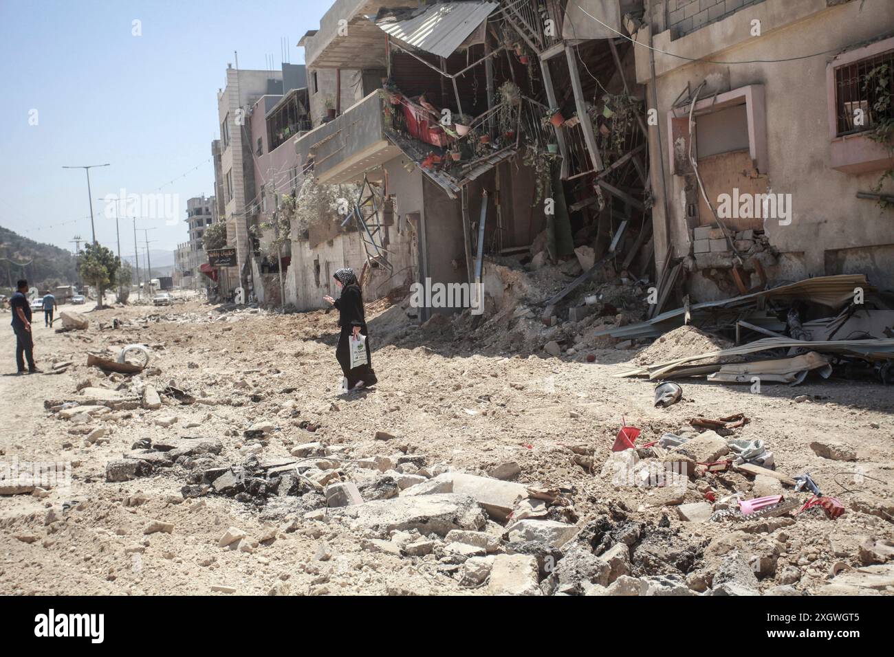 Tulkarm, Palestine. 10th July, 2024. Palestinians seen around remains ...