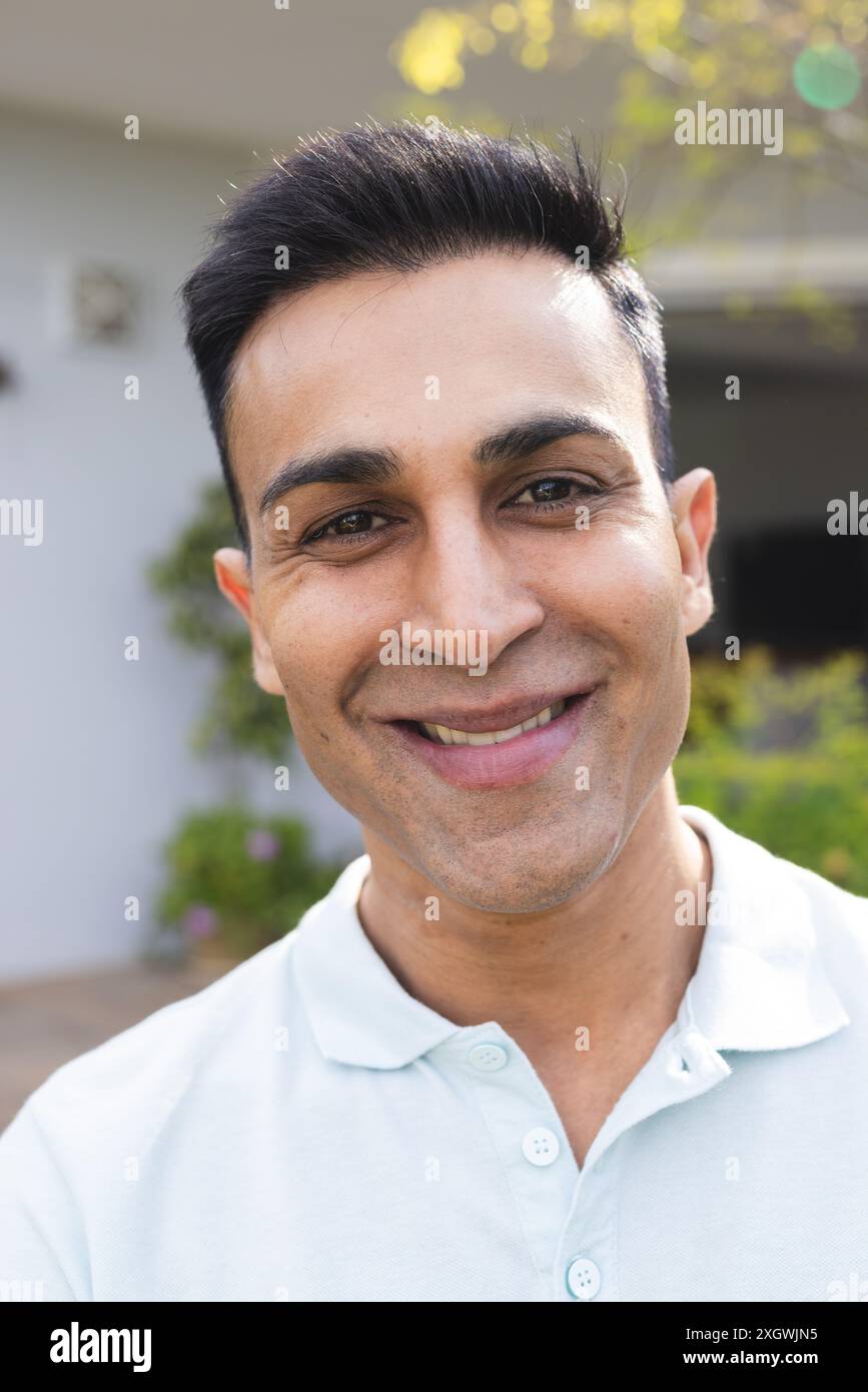 Middle Eastern man smiles warmly outdoors, unaltered. His cheerful ...