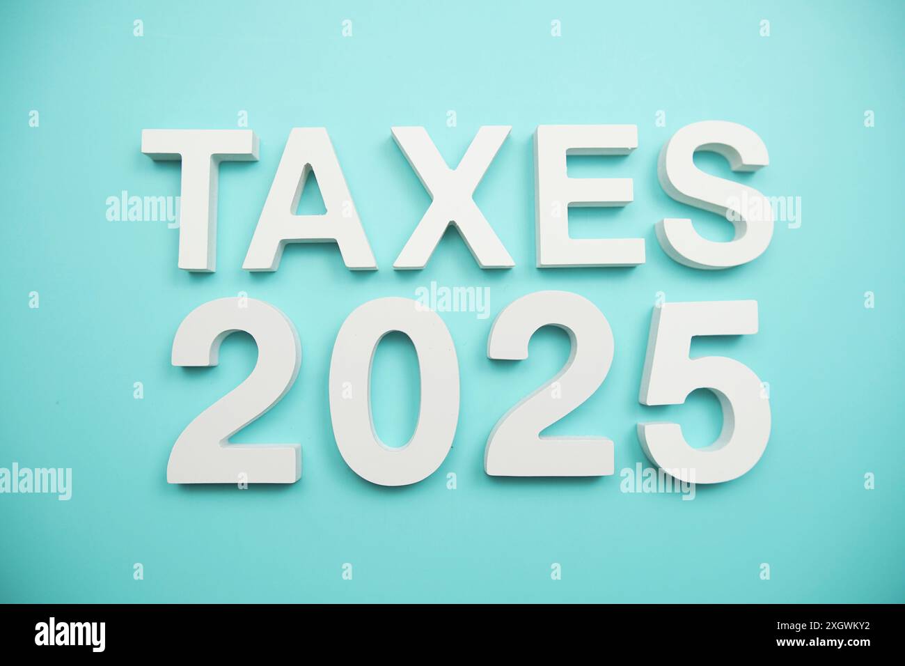 Taxes 2025 alphabet letters on blue background Stock Photo - Alamy
