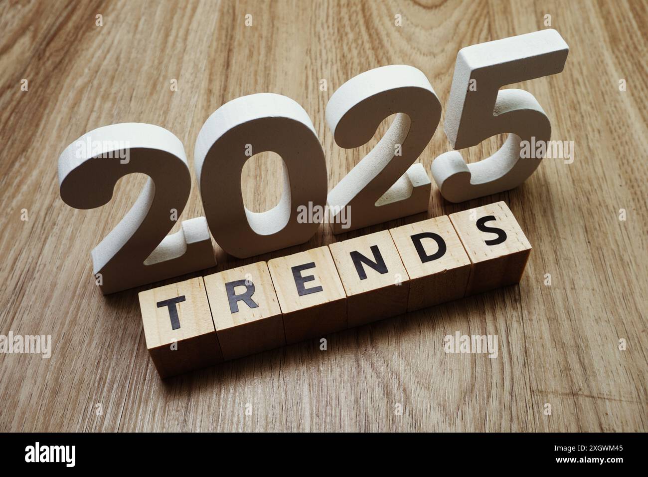 Trends 2025 word alphabet letters on wooden background Stock Photo - Alamy