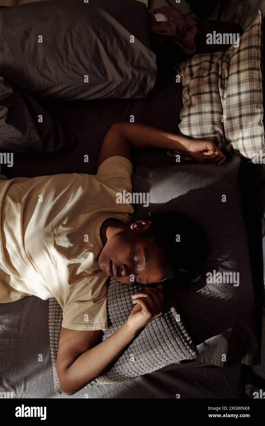 Above angle of young depressed woman with post traumatic syndrome lying ...