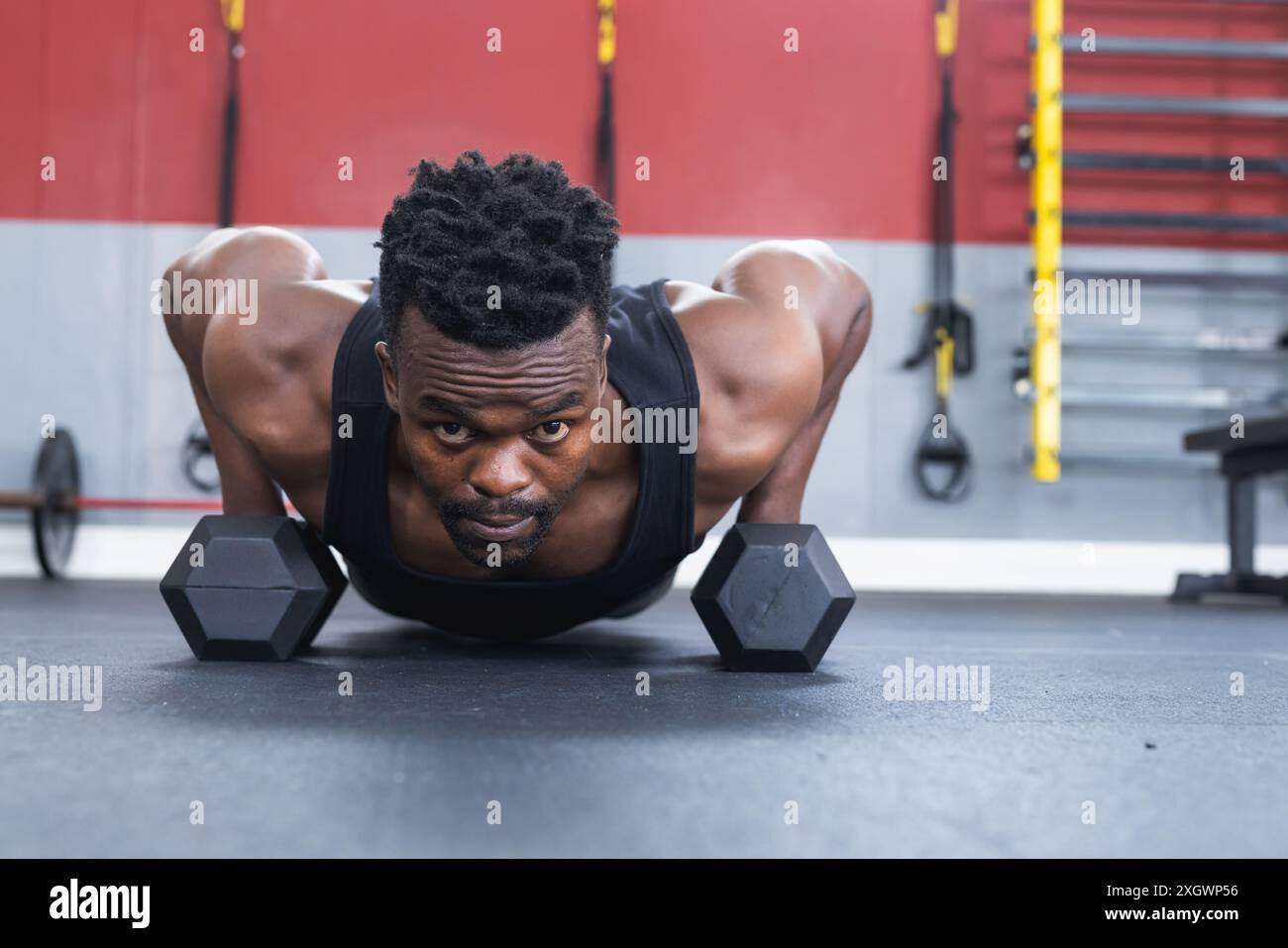 Fit African American man doing push-ups at the gym. His intense workout ...