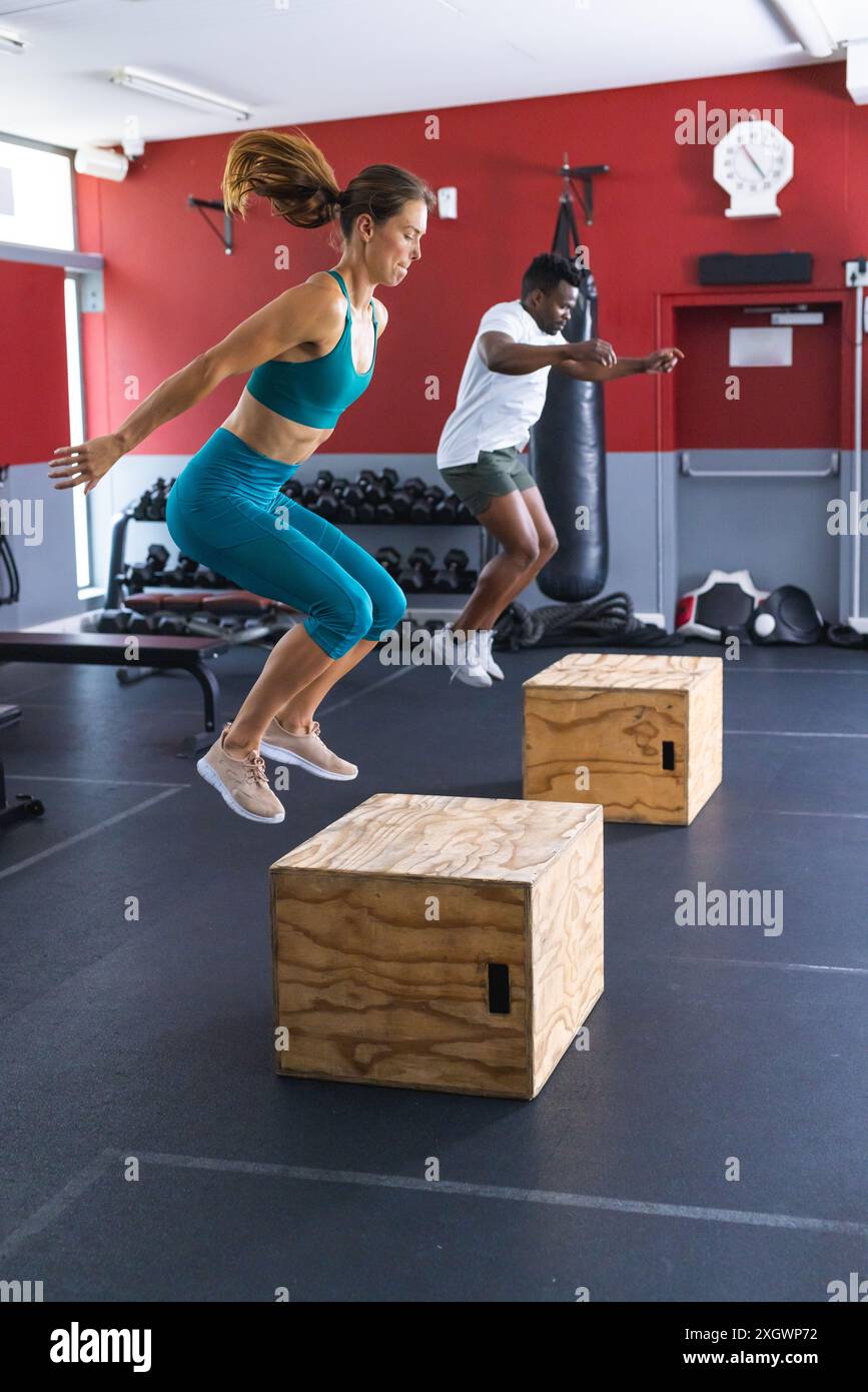 Fit young Caucasian woman and fit African American man perform box ...