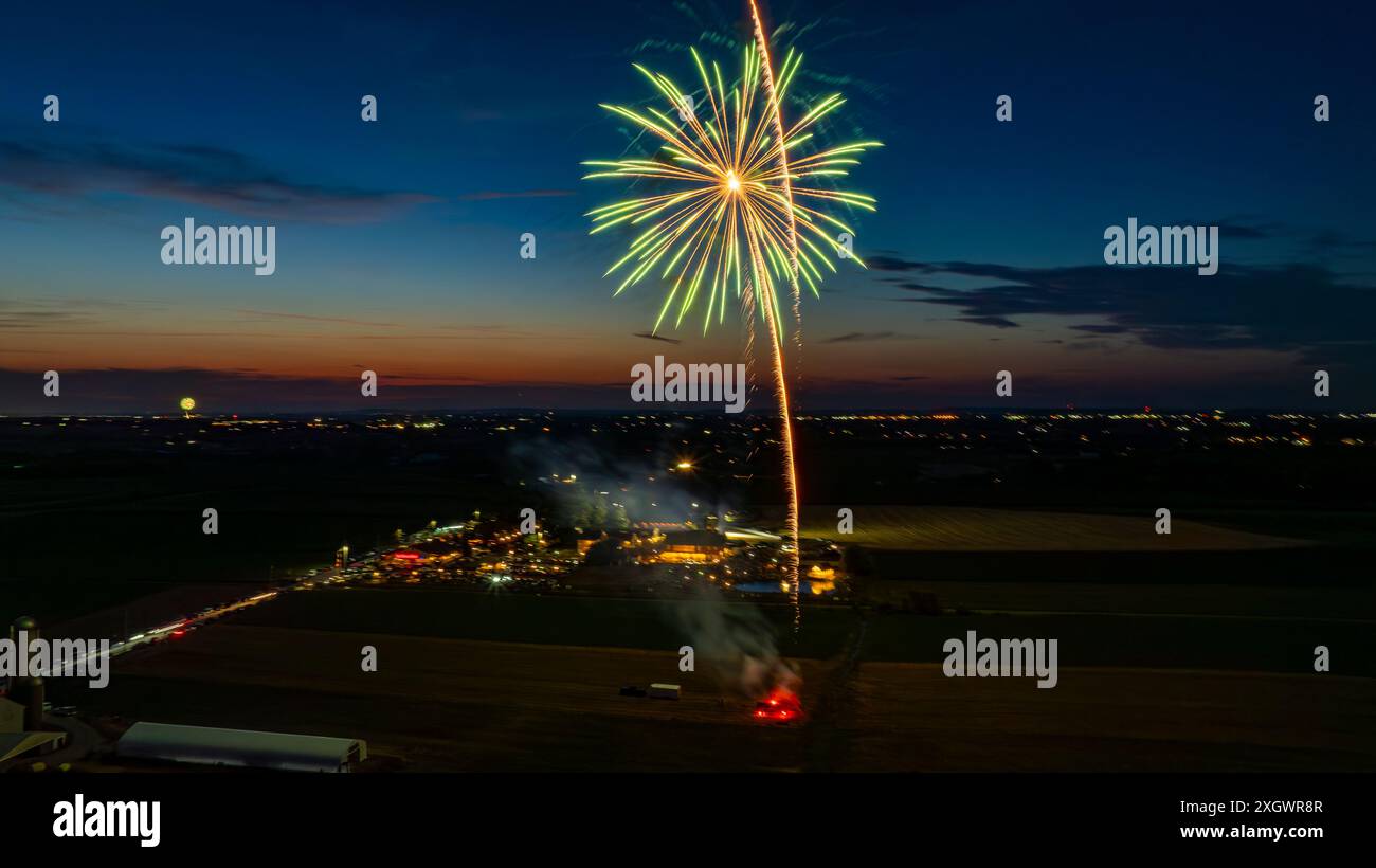 A Green And Yellow Firework Burst Illuminating The Night Sky Above A ...