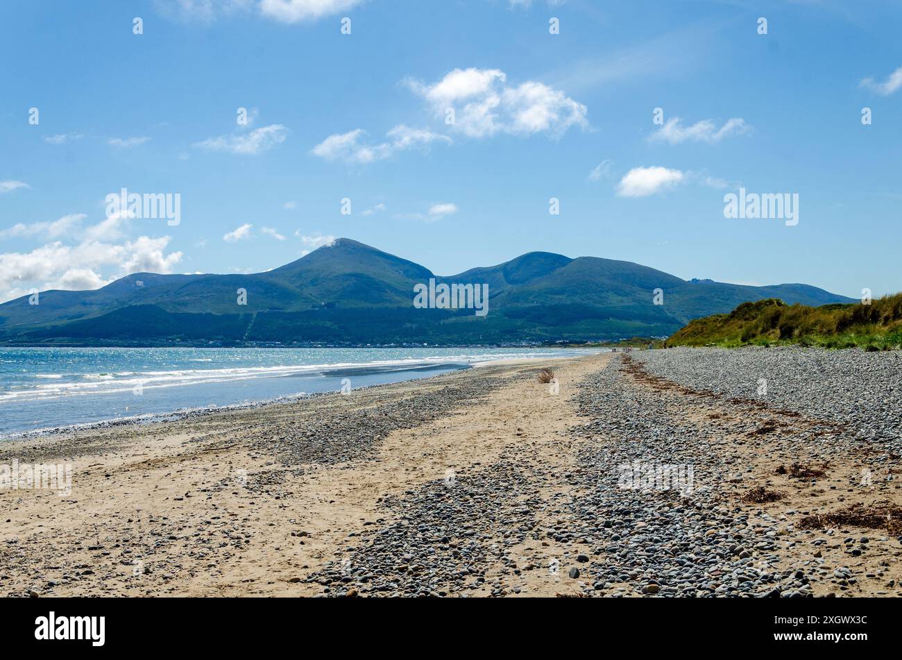 View of the Mourne Mountains from Murlough beach with blue sky and ...