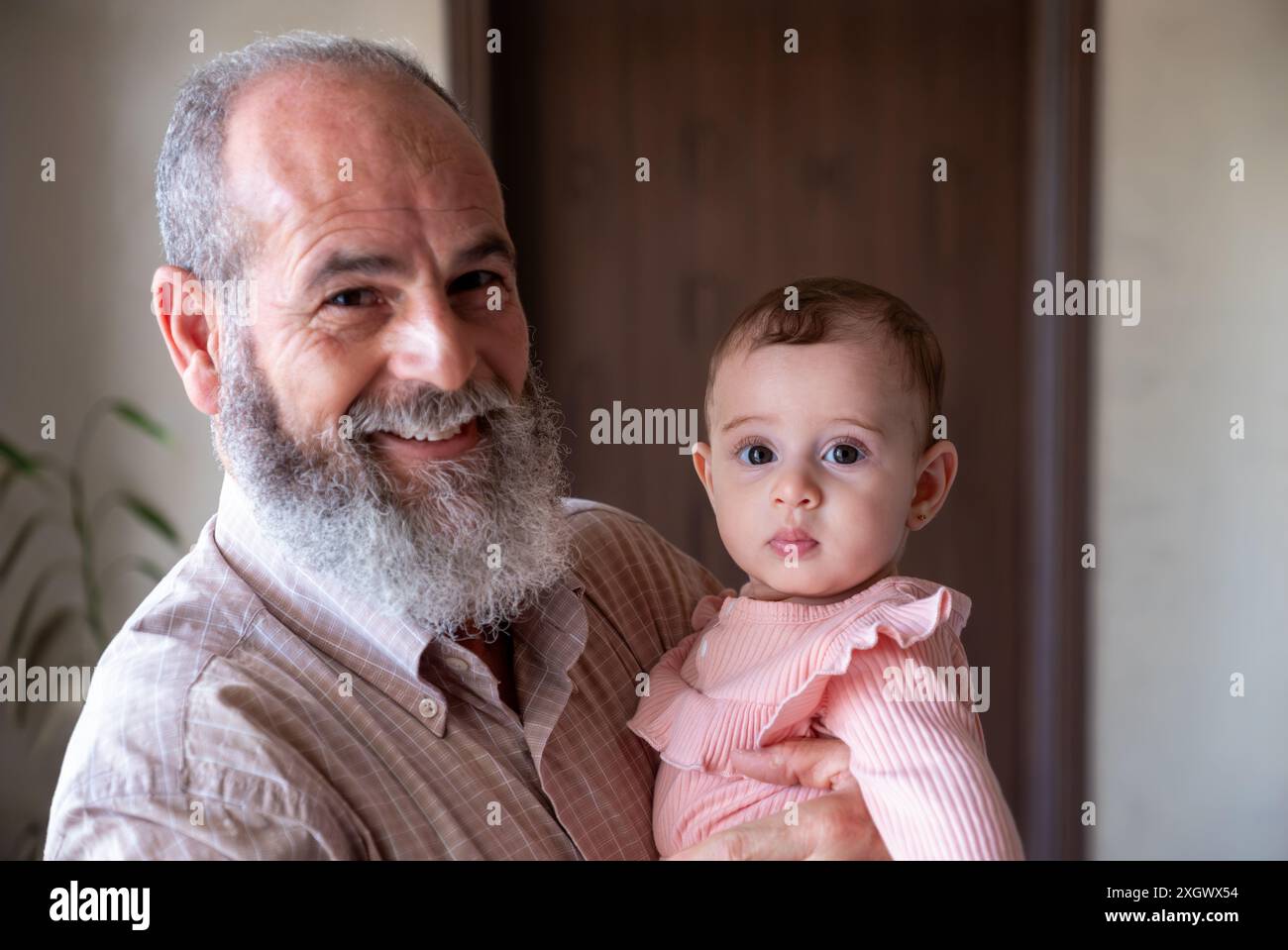 Grandfather having wonderful moment with his grandson holding him in ...