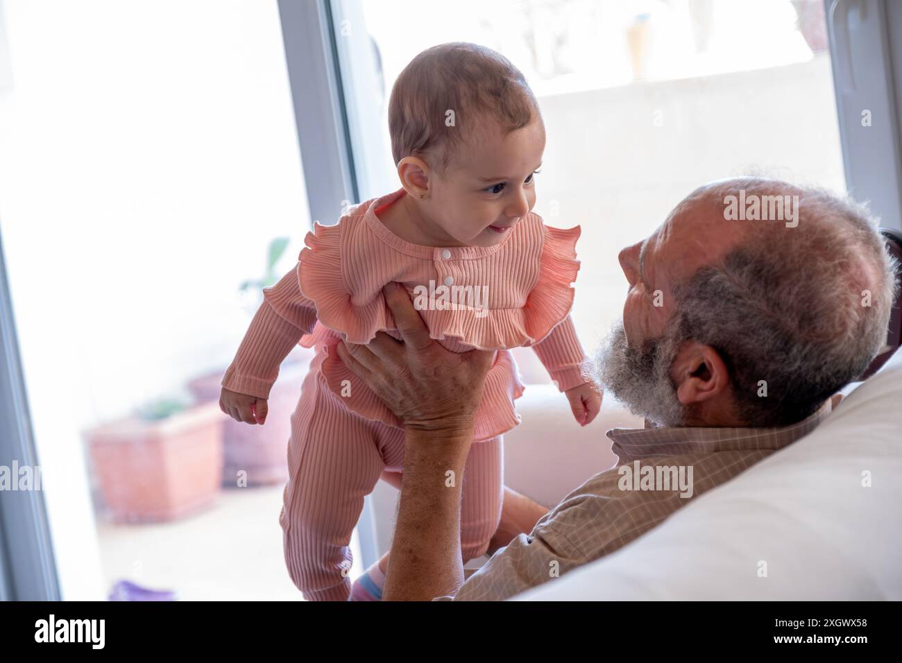 Portrait for newborn with his grandfather in family house in lovely ...