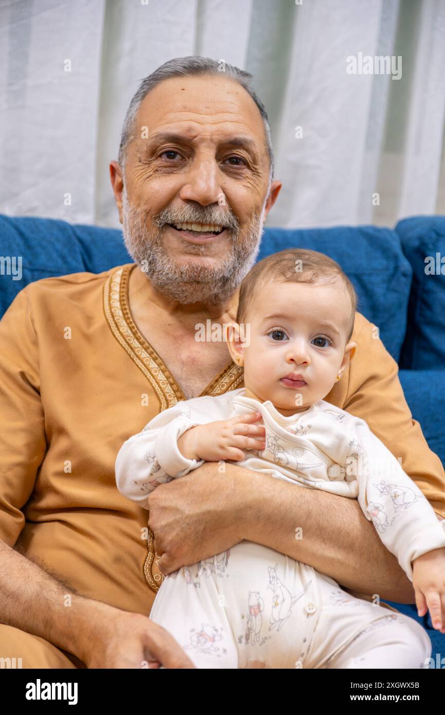 Grandfather having wonderful moment with his grandson holding him in ...