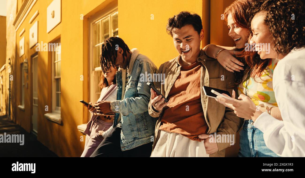 Happy friends smartphones socializing hi-res stock photography and ...