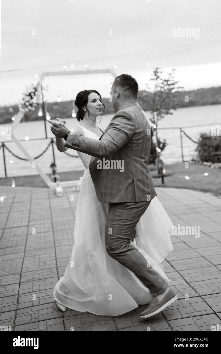 the first wedding dance of the bride and groom inside the restaurant ...