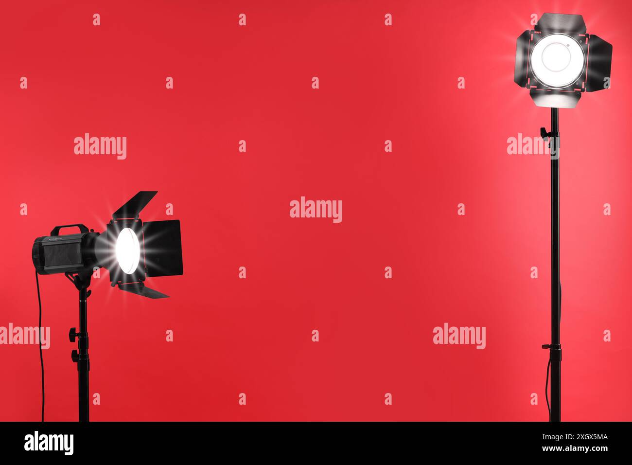 Red photo background and professional lighting equipment in studio ...