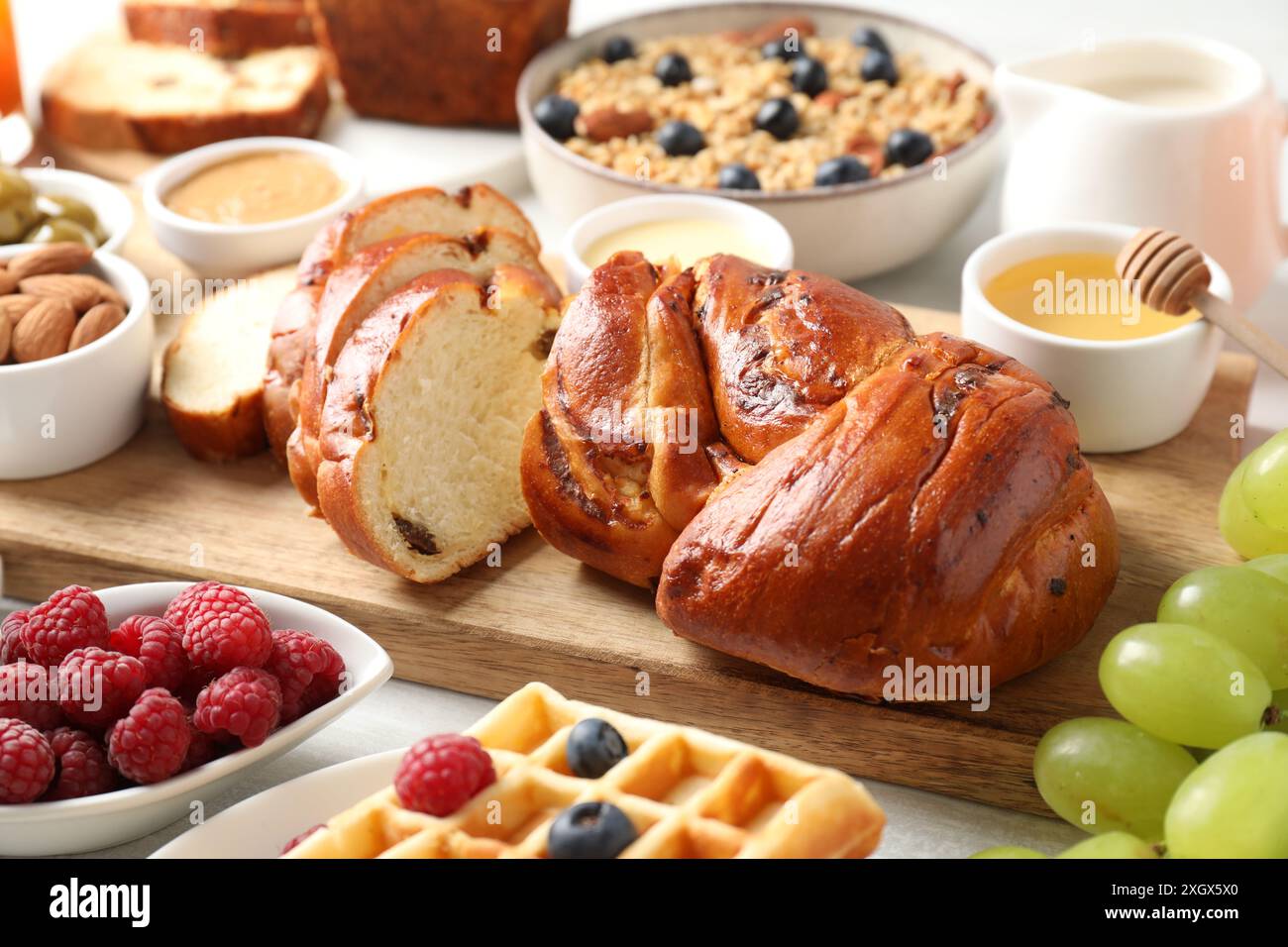 Different meals served for breakfast on white table Stock Photo - Alamy