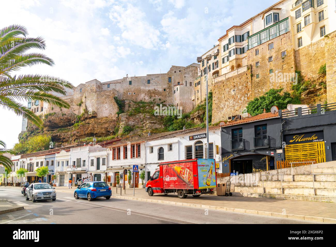The whitewashed cliffside buildings with sidewalk cafes and shops below ...