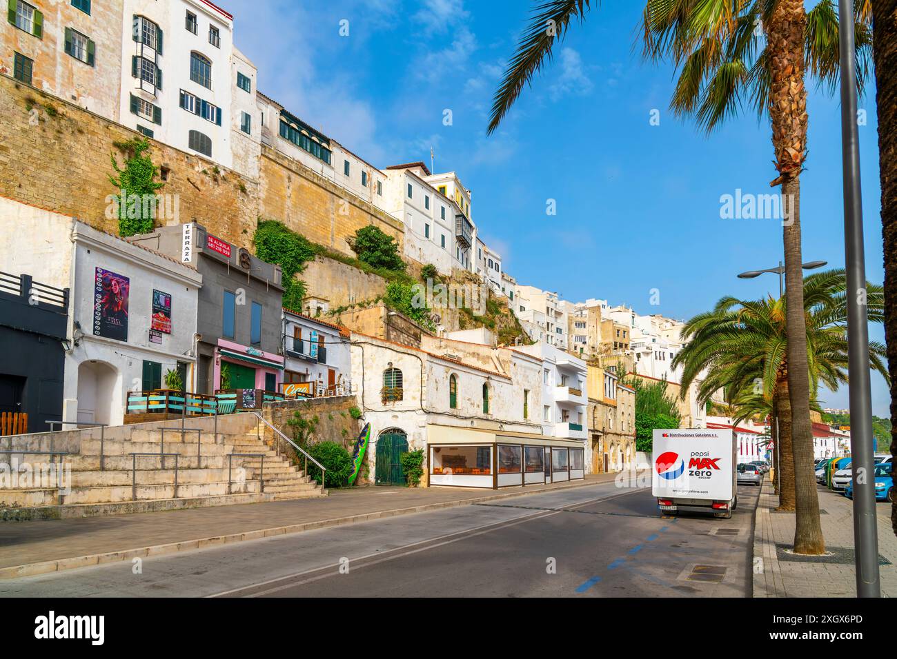 The whitewashed cliffside buildings with sidewalk cafes and shops below ...