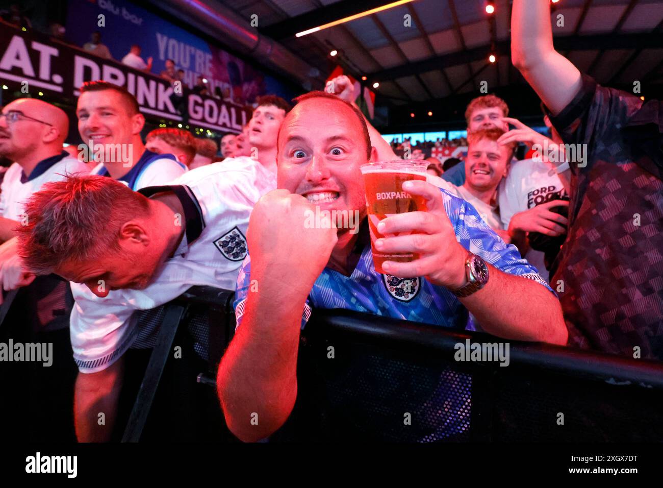 England fans celebrate at BOXPark Wembley, London, after a screening of ...