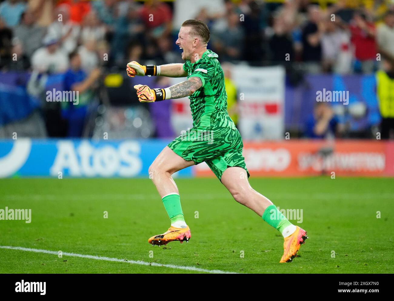 England goalkeeper Jordan Pickford celebrates after team-mate Ollie ...