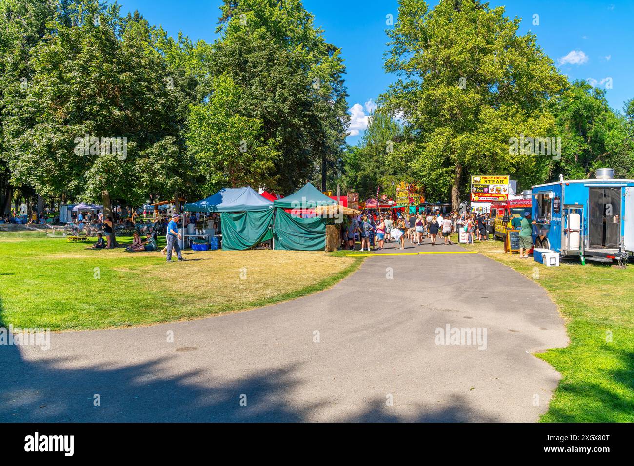Food booth vendors and artists set up booths along Sherman Ave. with ...