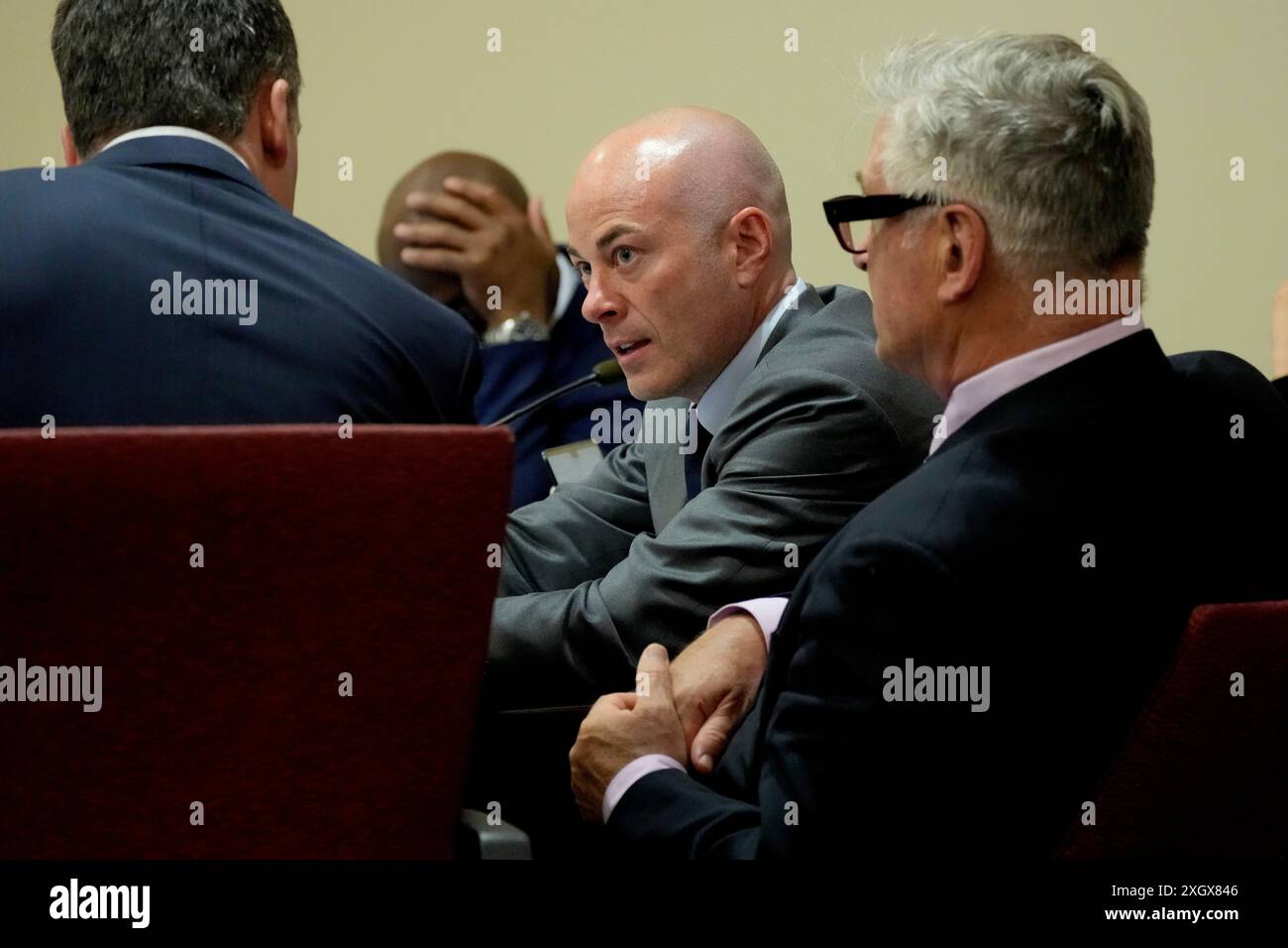 Attorney Luke Nikas, center, confers with attorney Alex Spiro, left ...